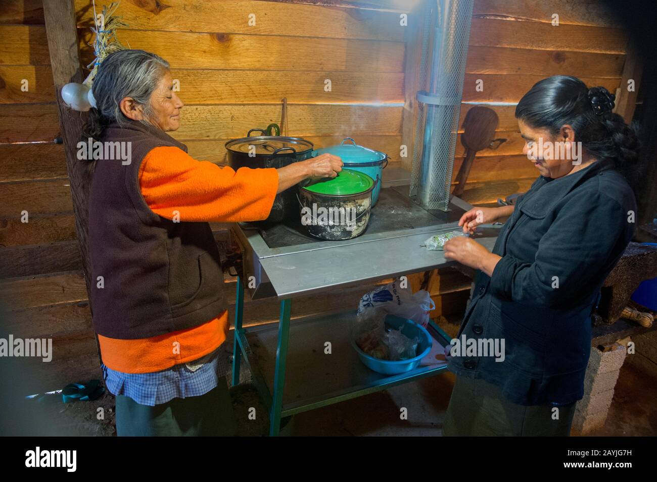 Women cooking in the kitchen of a house of the Mixtec village of San ...