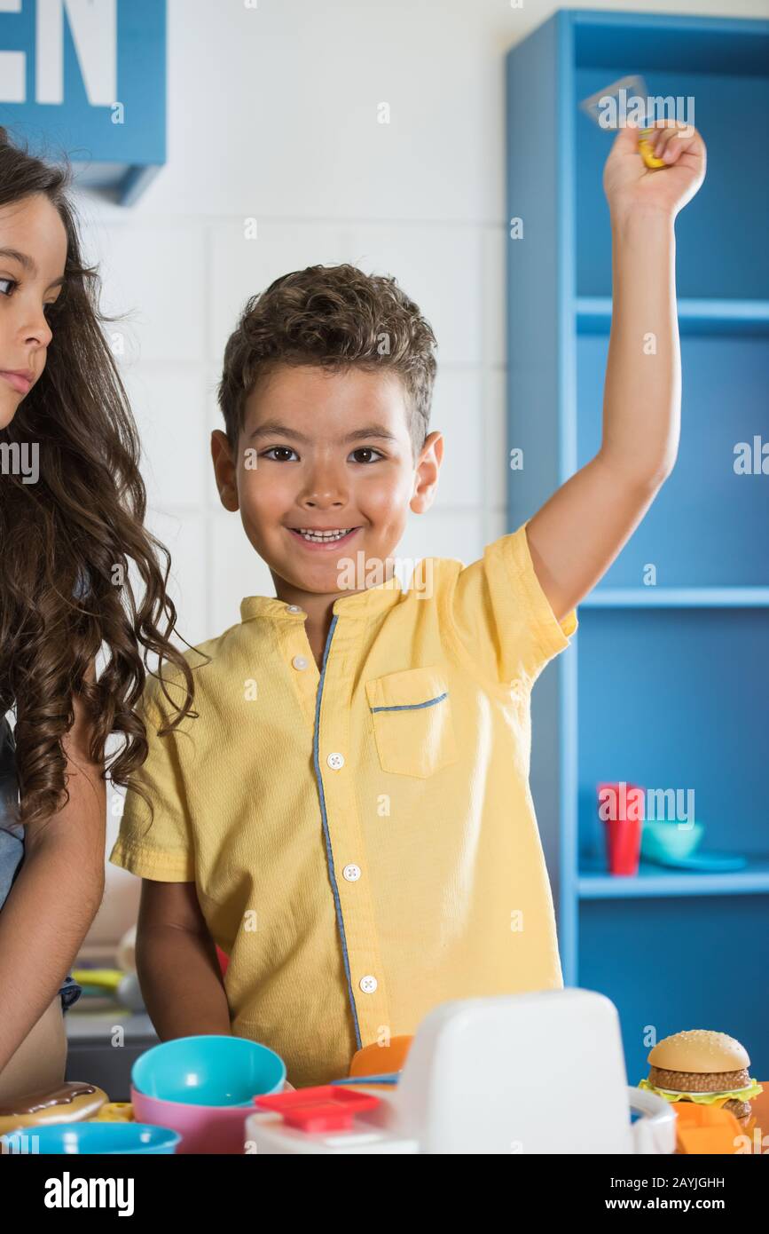 Happy kid looking at camera in playroom Stock Photo - Alamy