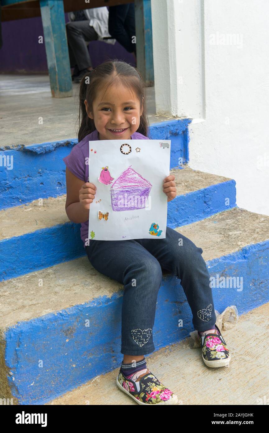 A girl is showing her artwork in the Mixtec village of San Juan ...