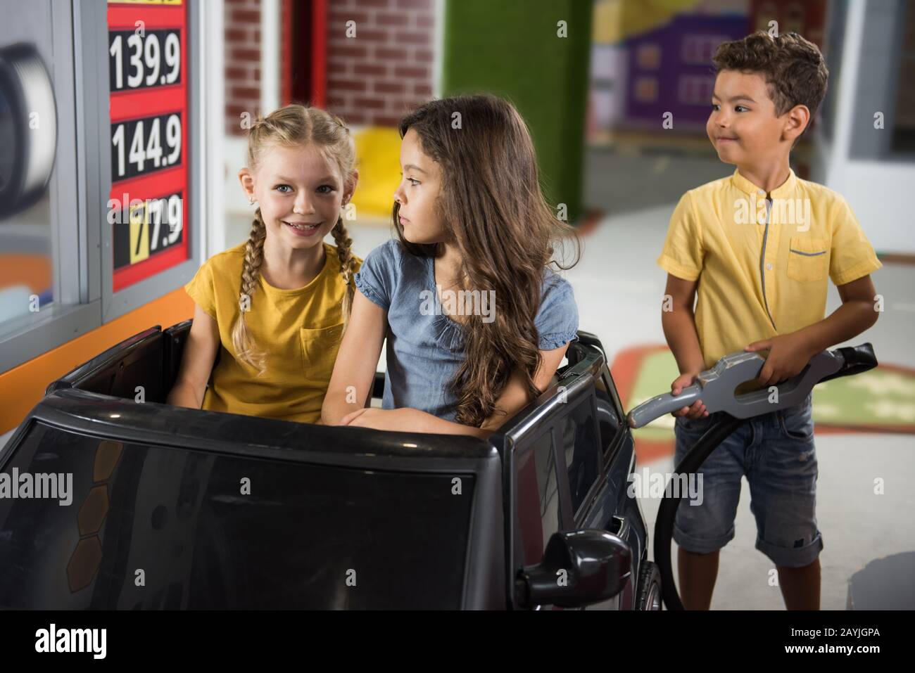 Kids at a gas station Stock Photo - Alamy