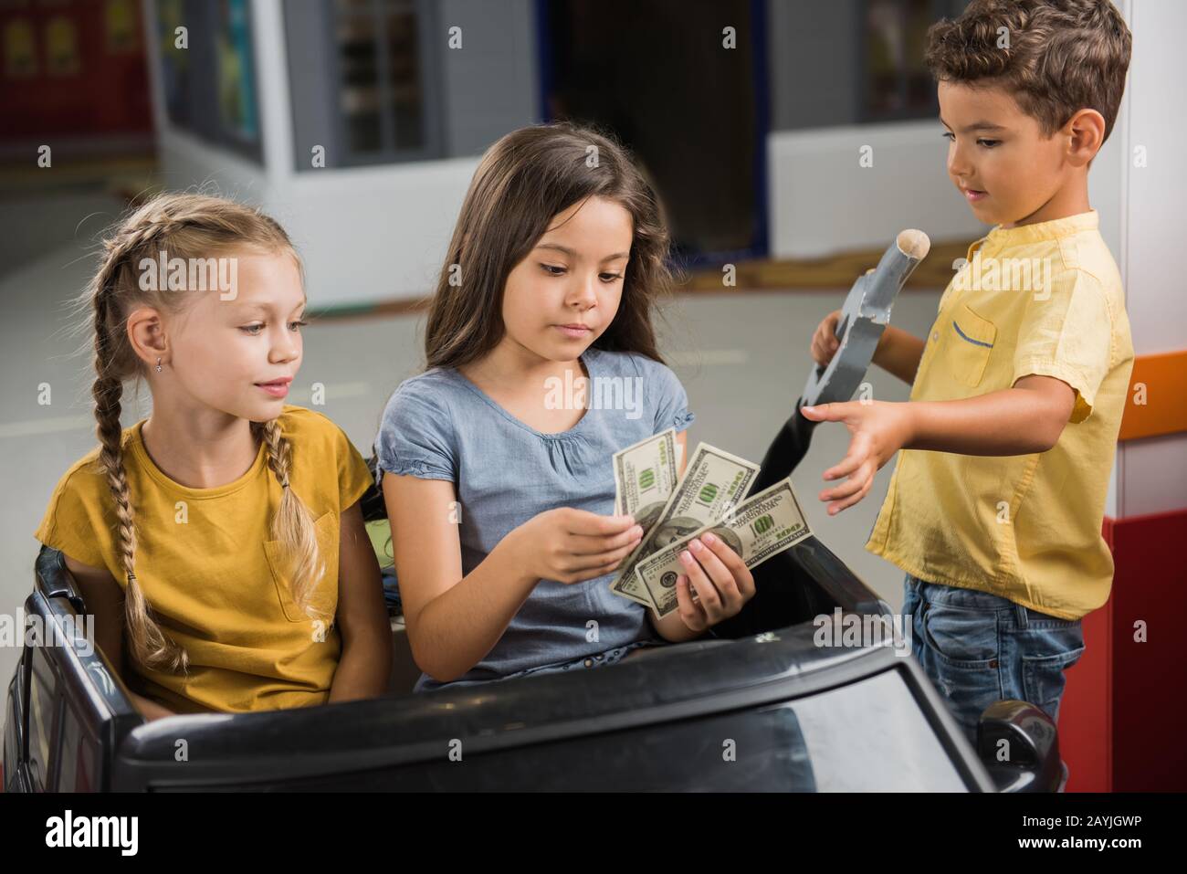 Children paying money at gas station Stock Photo - Alamy