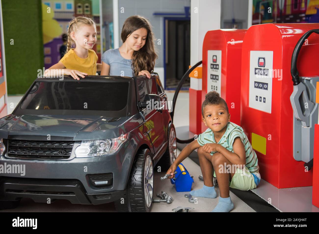 Little auto mechanic repairing toy car in playroom Stock Photo - Alamy