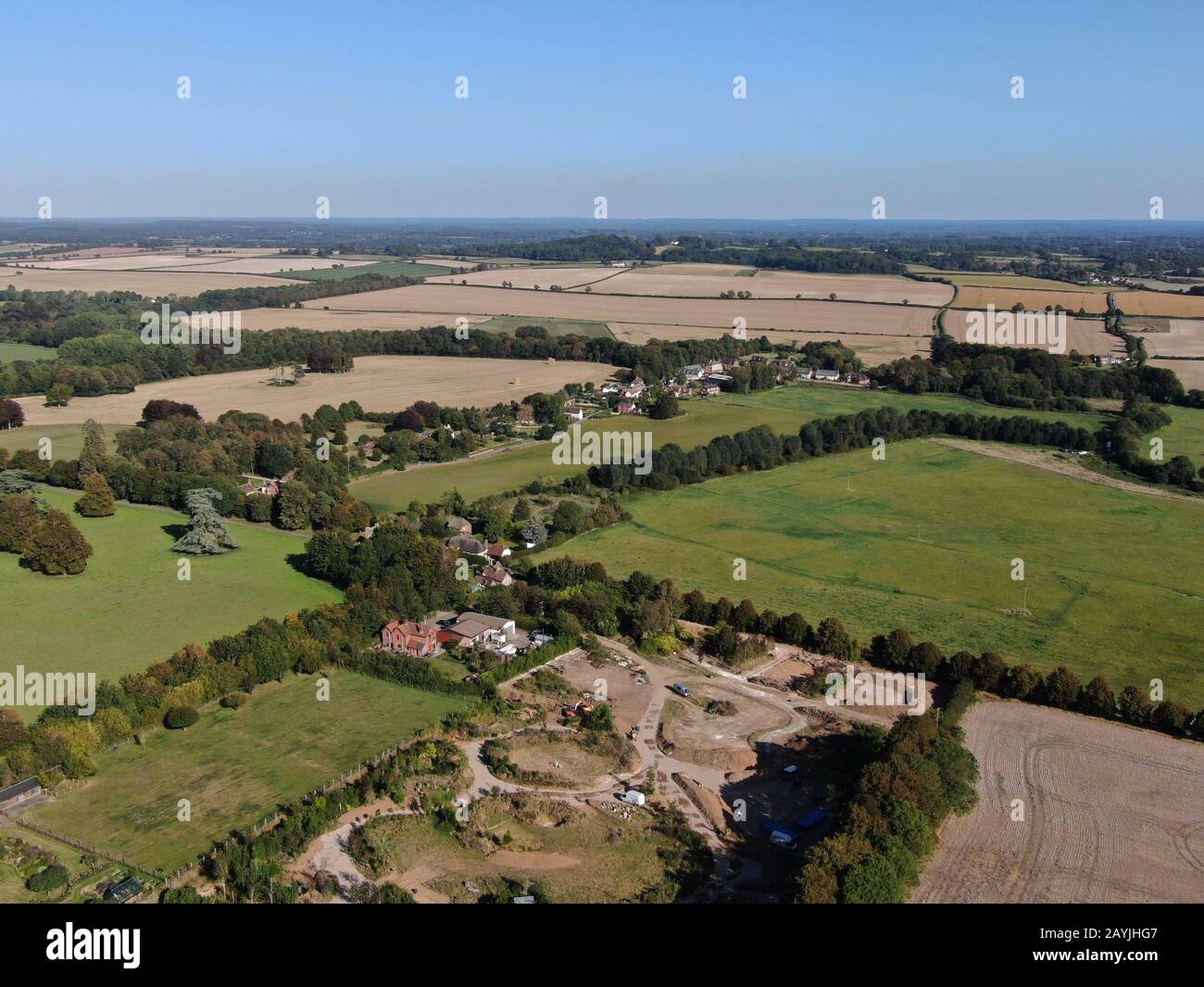 aerial view of Dorset countryside with green and golden flat fields in ...