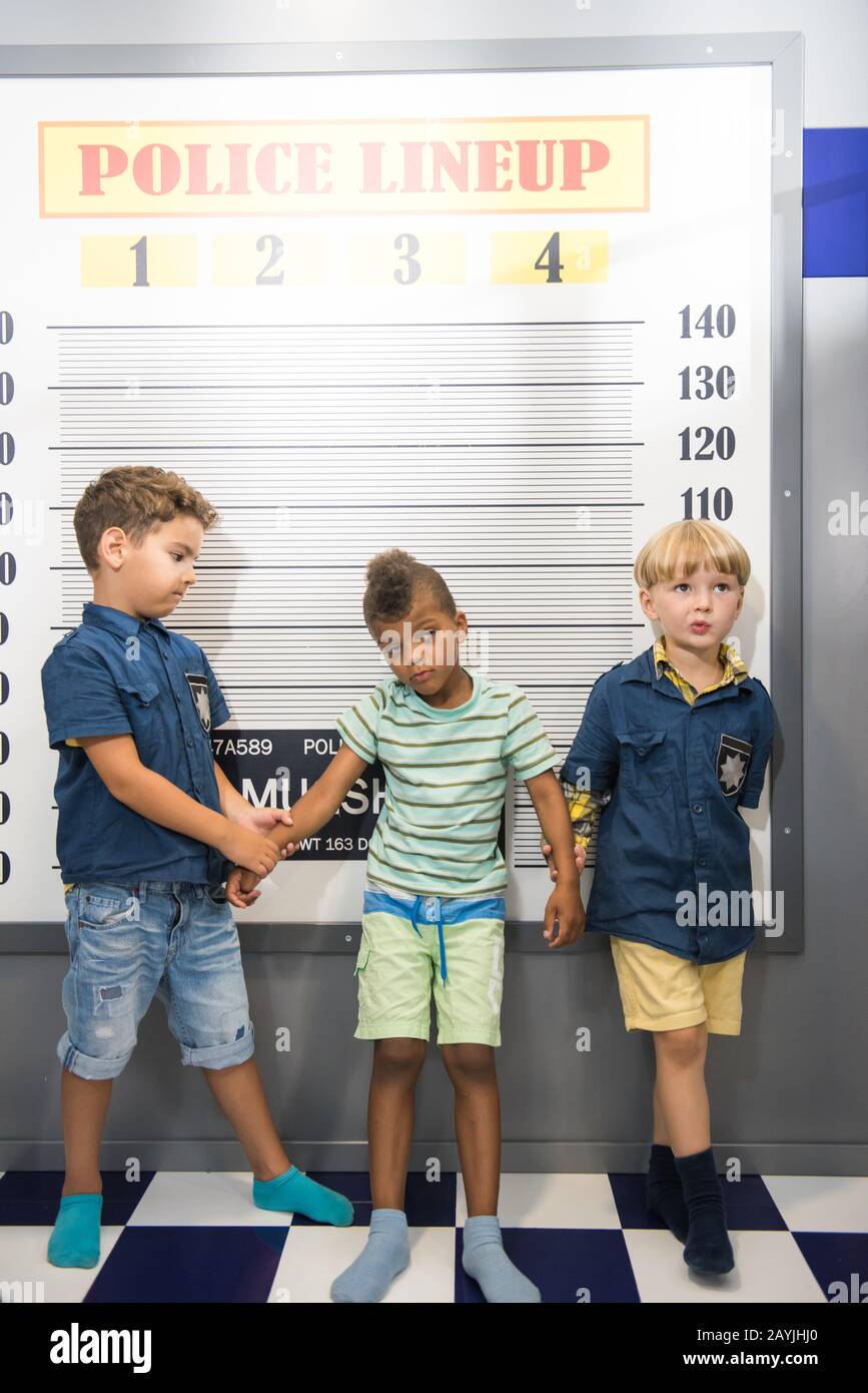 Little boys playing police in entertainment center Stock Photo - Alamy