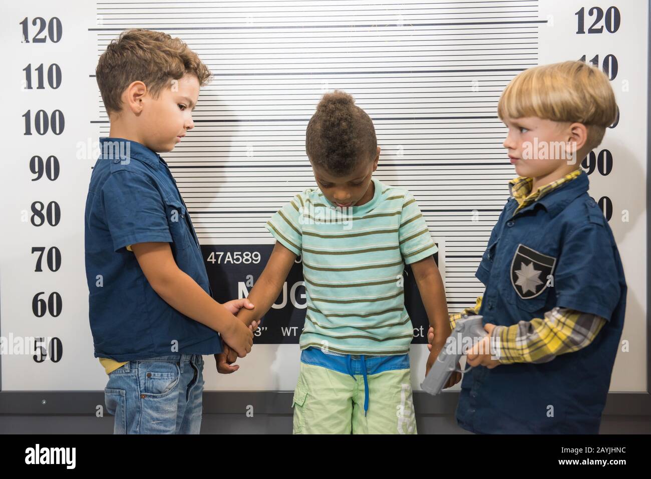 Little boys playing police and prisoner Stock Photo - Alamy
