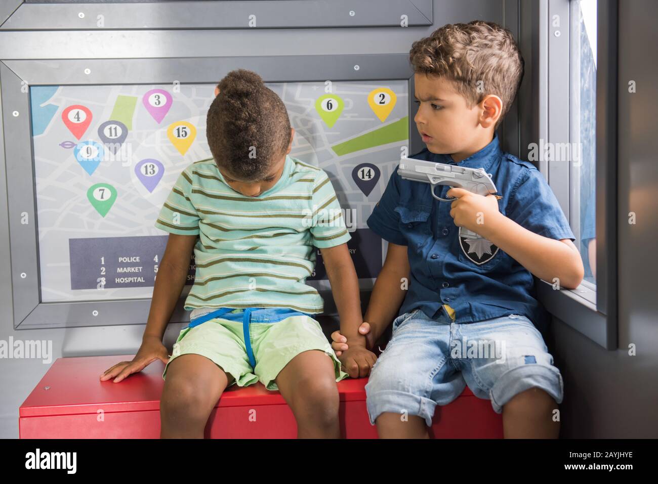 Little policeman with gun caught a thief Stock Photo - Alamy