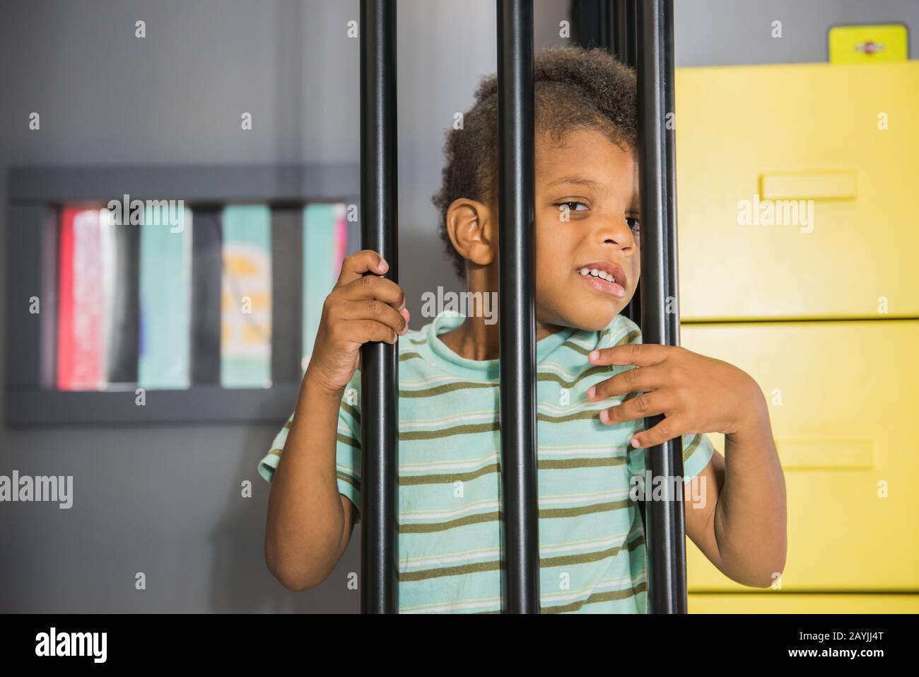 Little boy playing prisoner indoor Stock Photo - Alamy