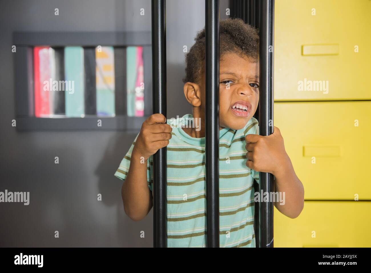 Little boy in prison in playroom Stock Photo - Alamy