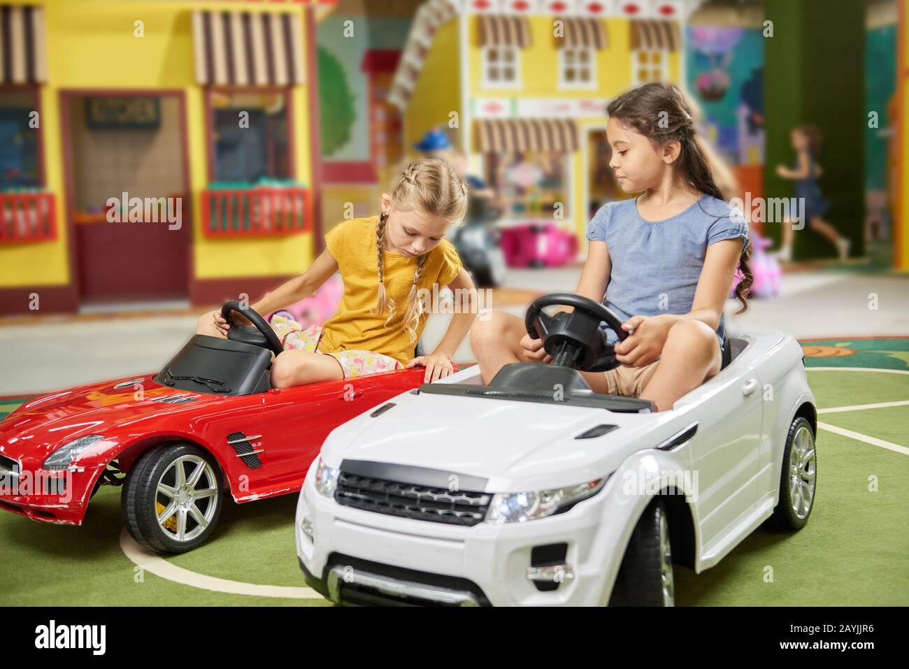 Beautiful little girls having fun in entertainment center Stock Photo ...