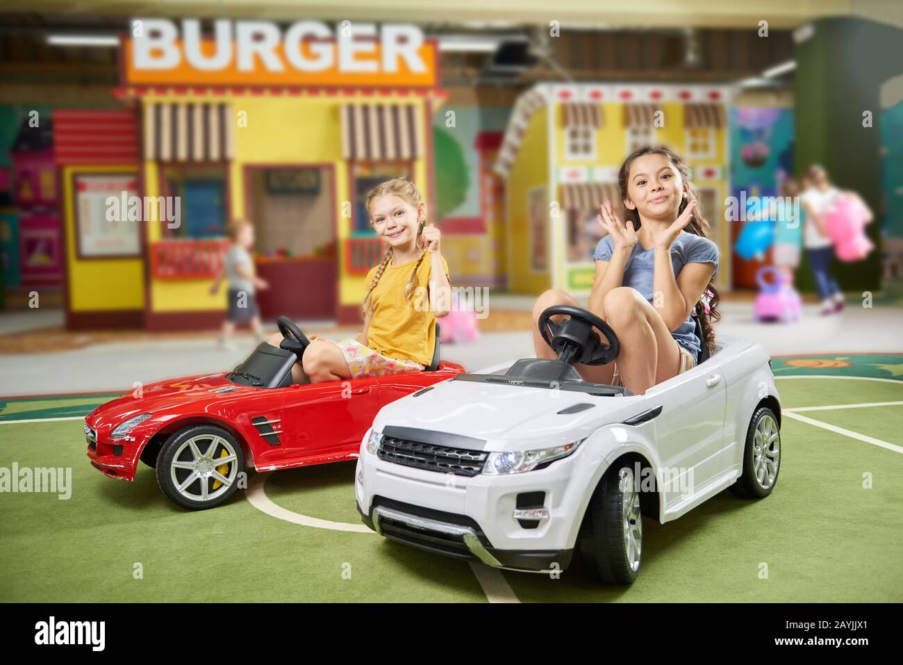 Excited little girls at indoor game center Stock Photo - Alamy
