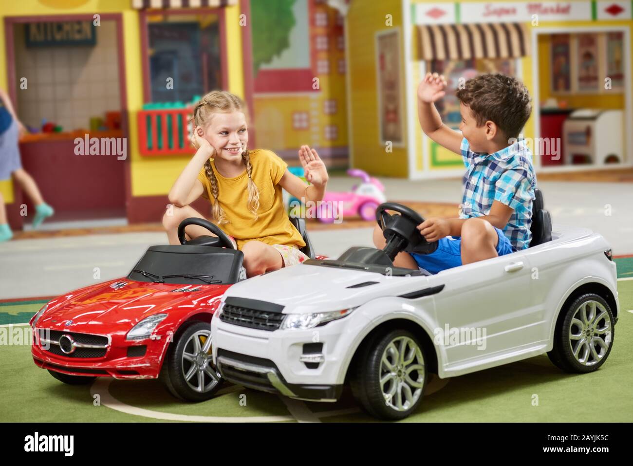 Little boy pushing toy car indoor Stock Photo - Alamy