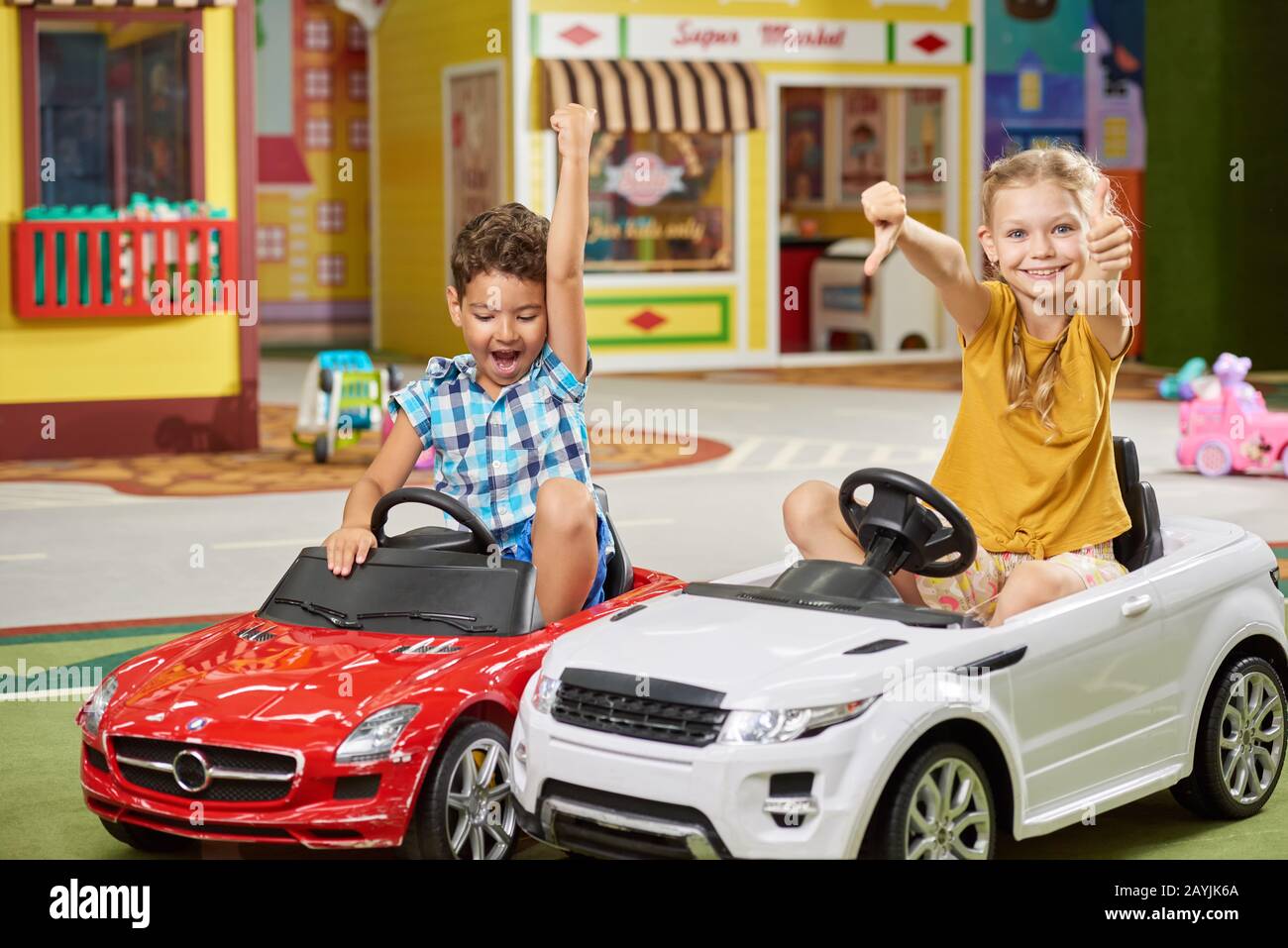 Two kids having fun in entertainment center Stock Photo - Alamy