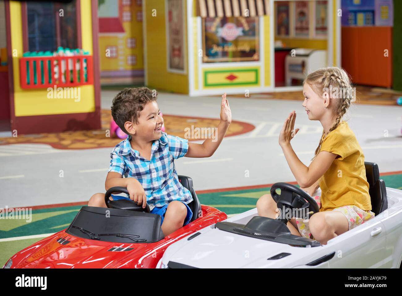 Two kids having fun in entertainment center Stock Photo - Alamy