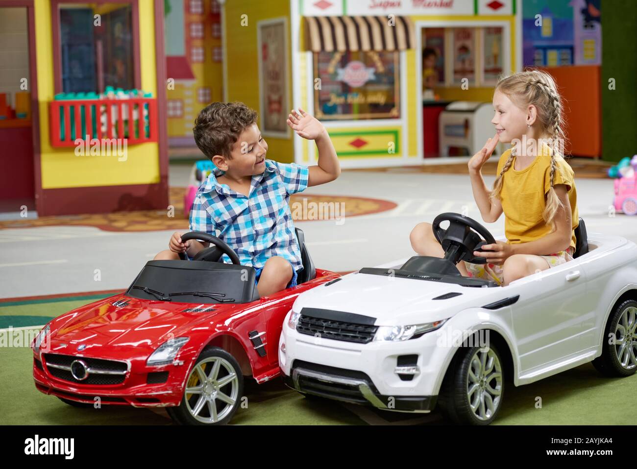 Two kids having fun in entertainment center Stock Photo - Alamy