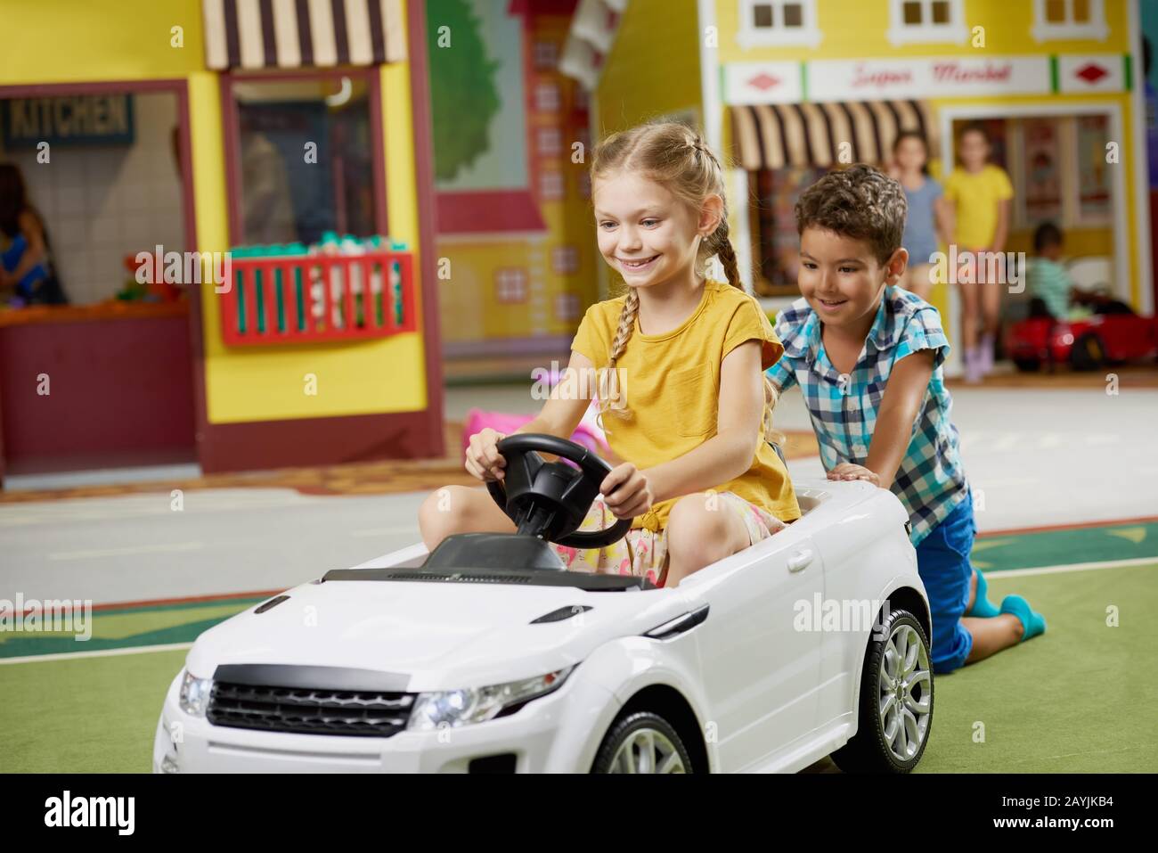 Little boy pushing toy car indoor Stock Photo - Alamy