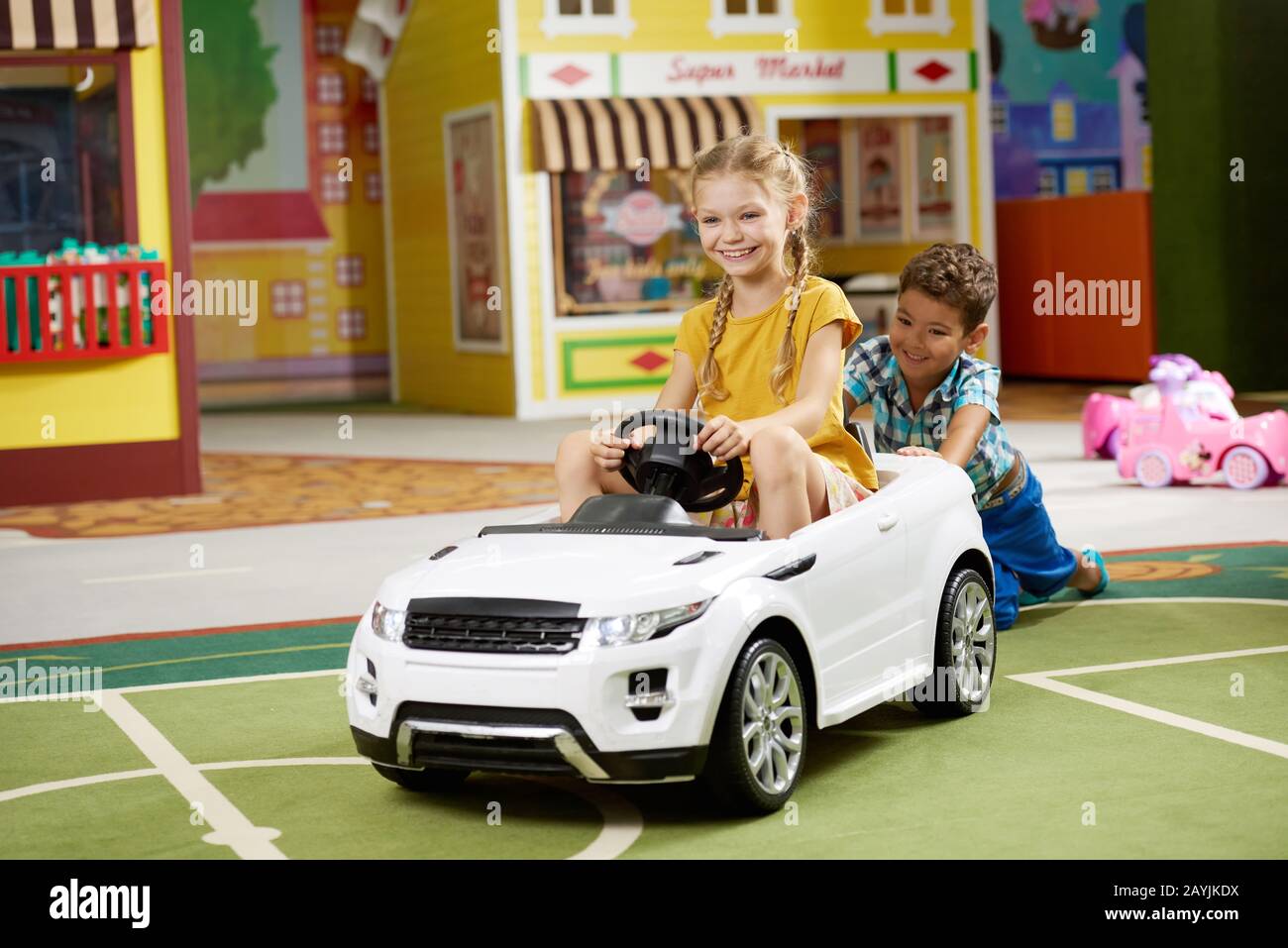 Kid Pushing A Car