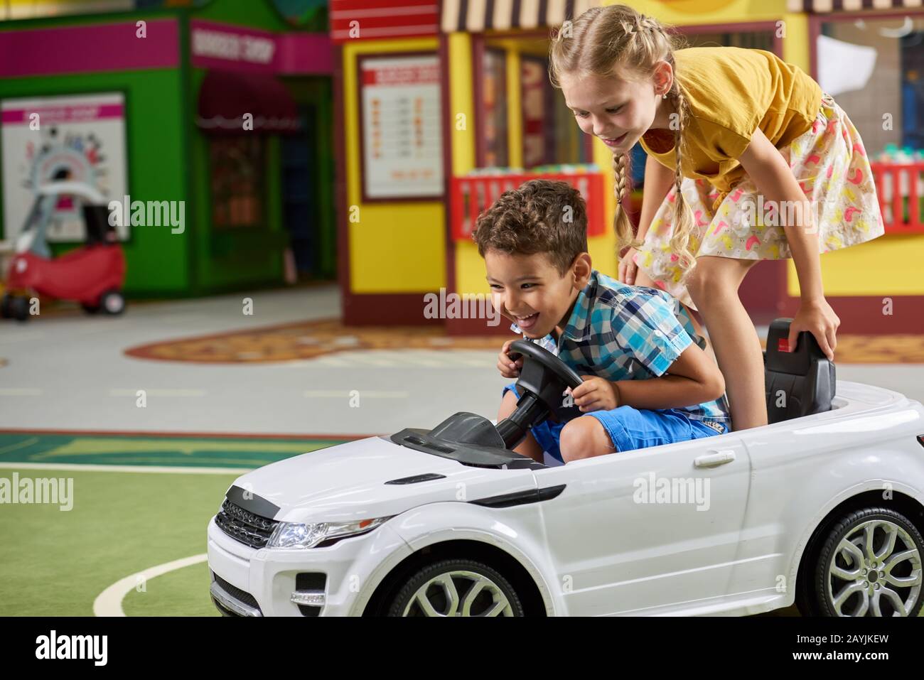 Two kids having fun in entertainment center Stock Photo - Alamy