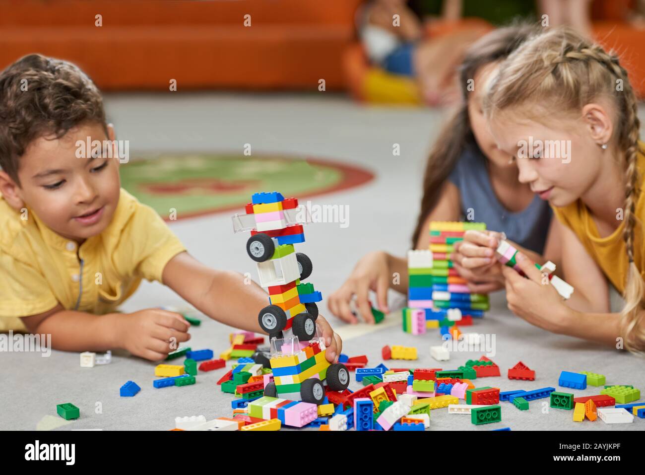 Little girls and boys play with blocks Stock Photo - Alamy