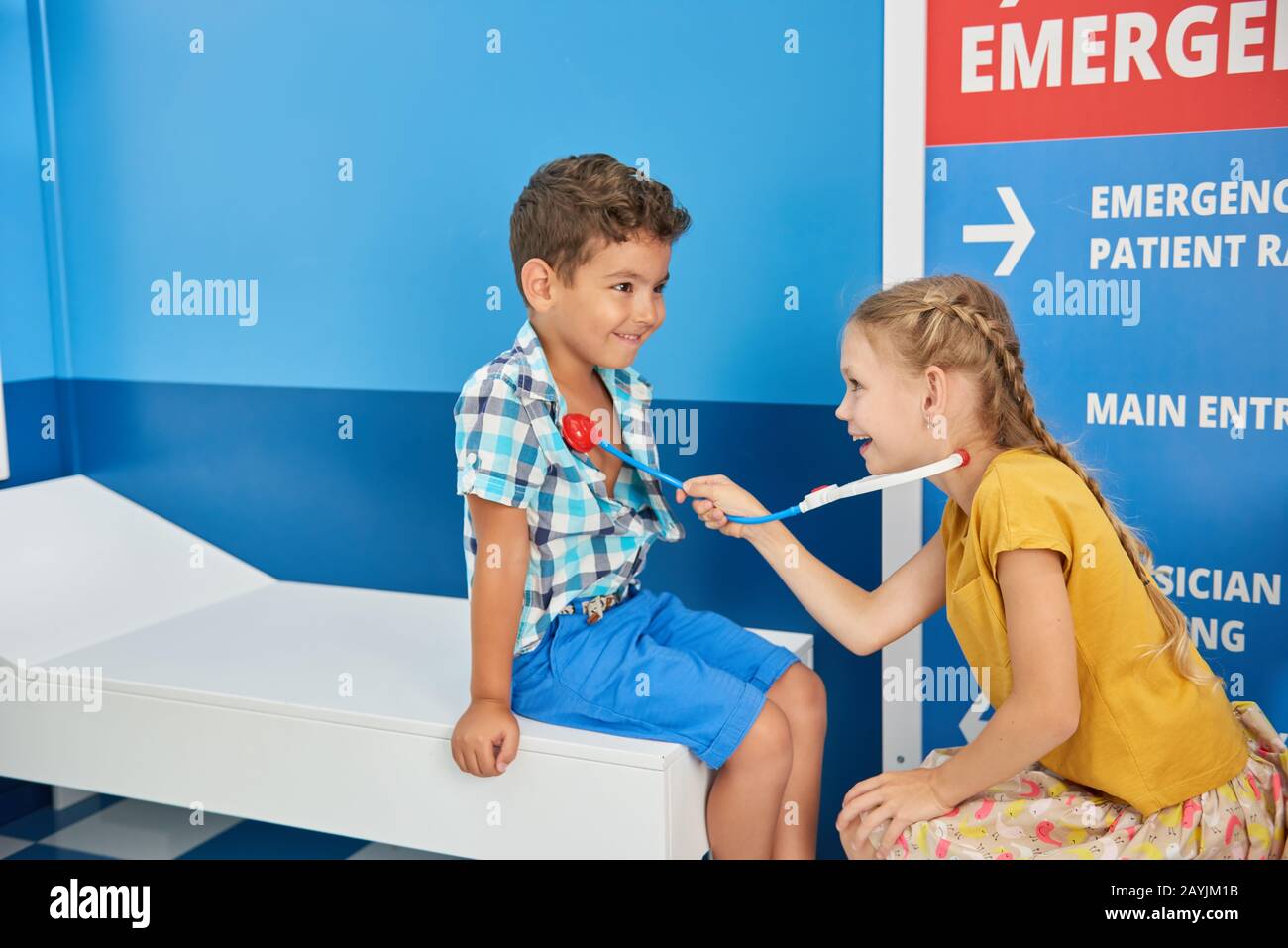 Two children playing doctor in playroom Stock Photo - Alamy