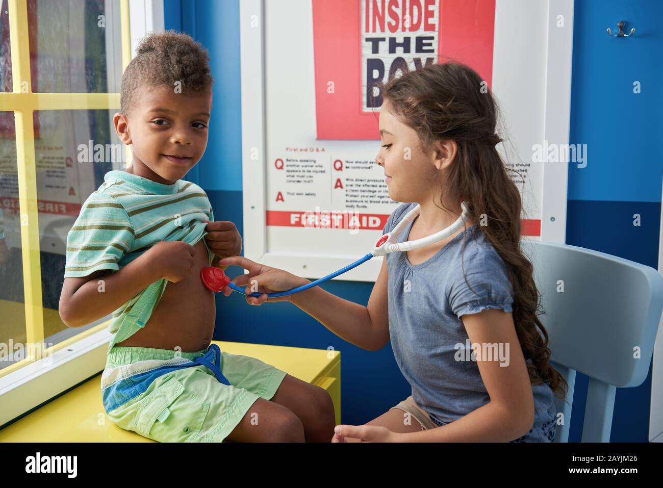 Two children playing doctor in playroom Stock Photo - Alamy