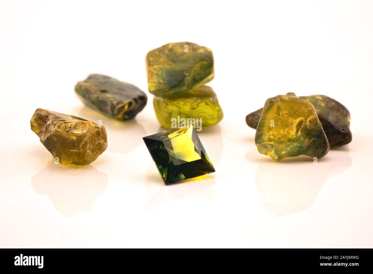 One square facet cut yellow green sapphire surrounded with uncut ...