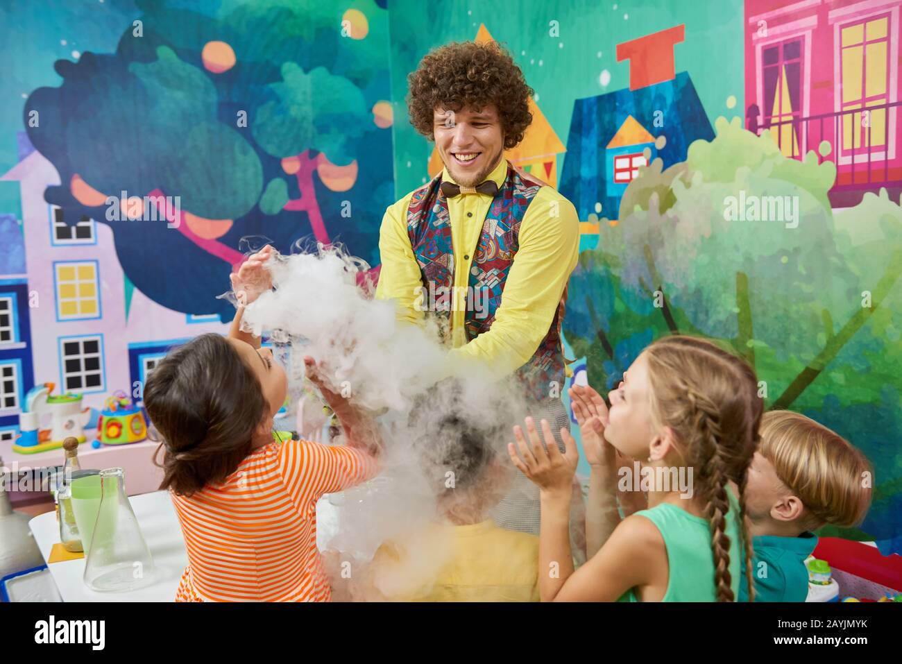 Animator with happy children indoor Stock Photo - Alamy