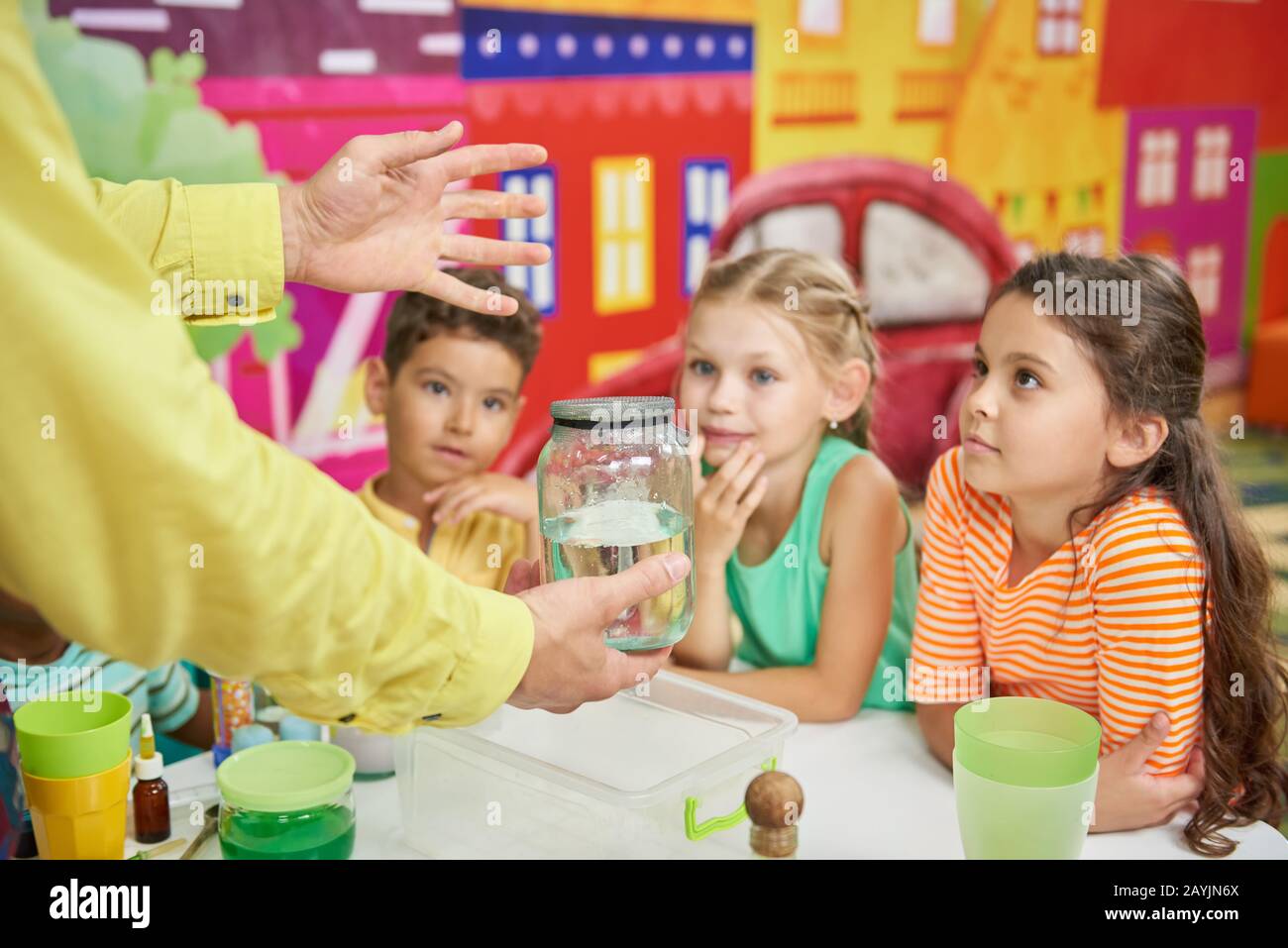 Kids watching animator carry out a science experiment Stock Photo - Alamy