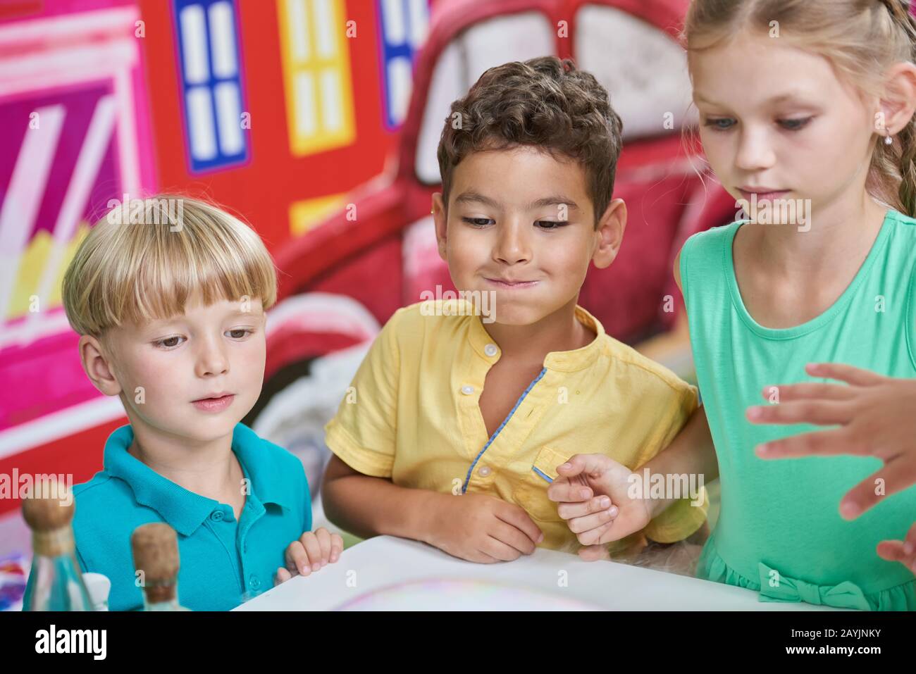Happy kids having fun in playroom Stock Photo - Alamy