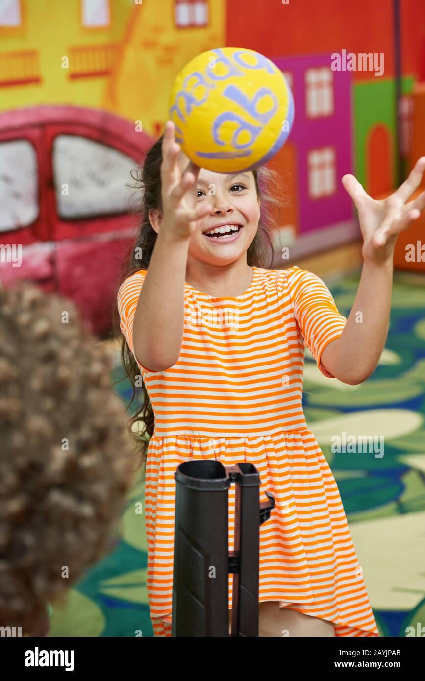Cute happy girl catching a ball Stock Photo - Alamy