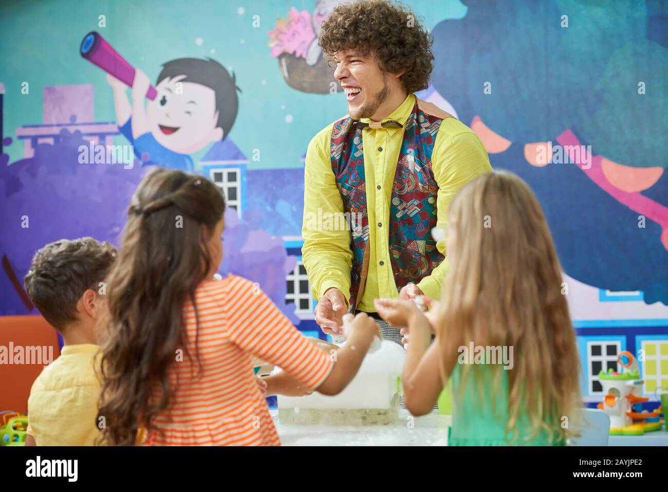 Cheerful entertainer doing science show for kids Stock Photo - Alamy