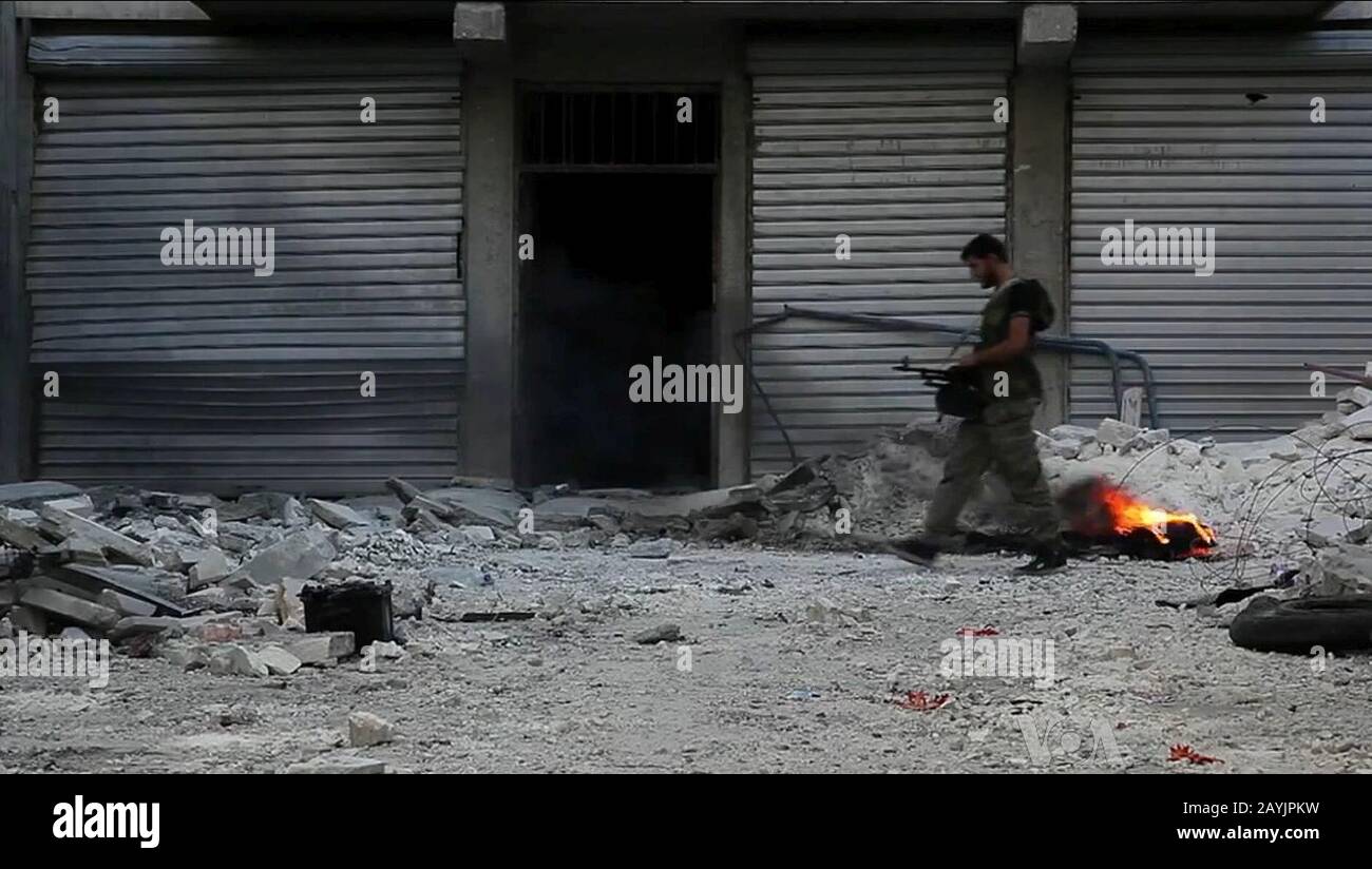 Free Syrian Army soldier walking among rubble in Aleppo Stock Photo - Alamy