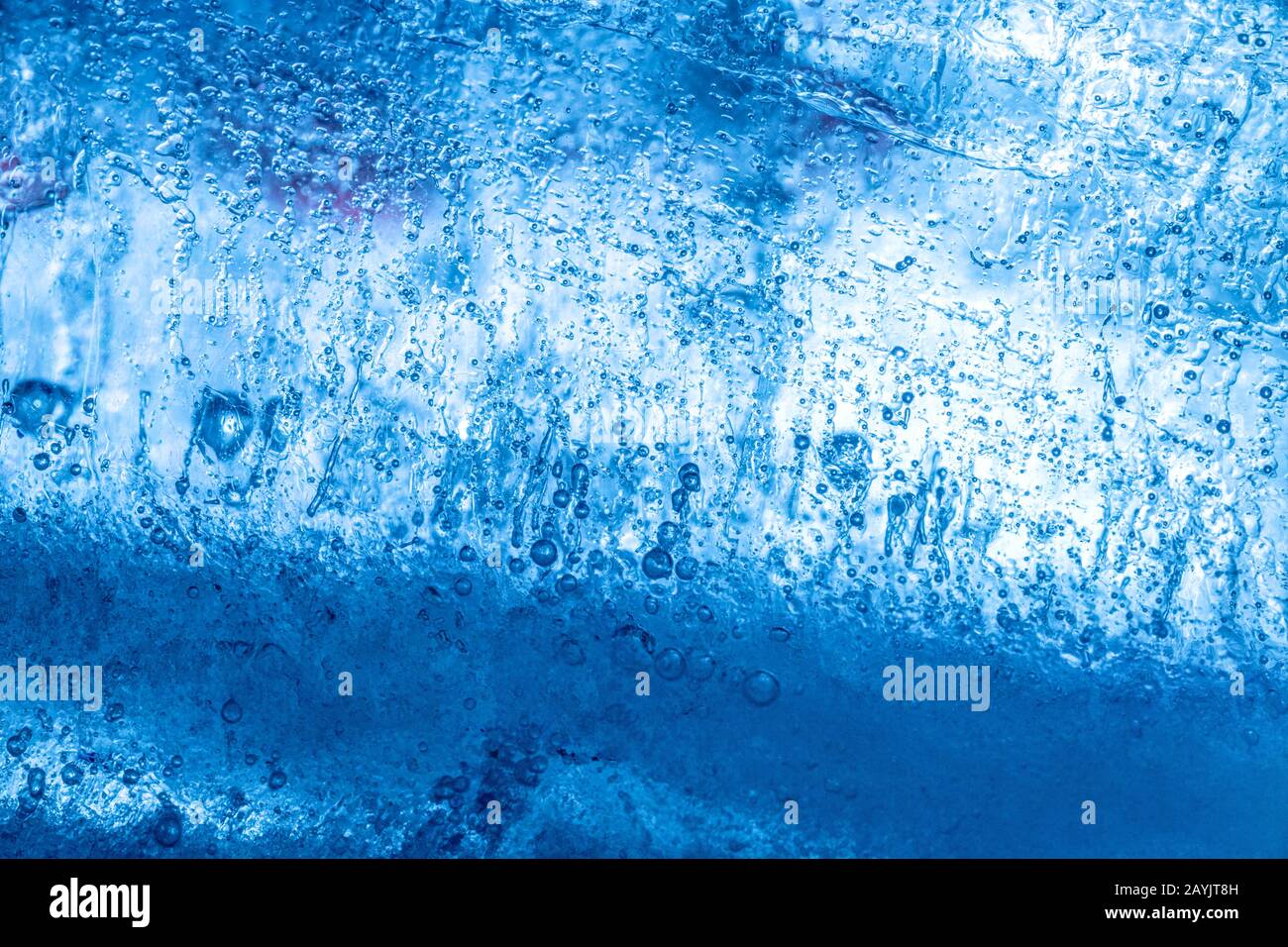 Illuminated ice block texture - abstract macro background in blue tones ...