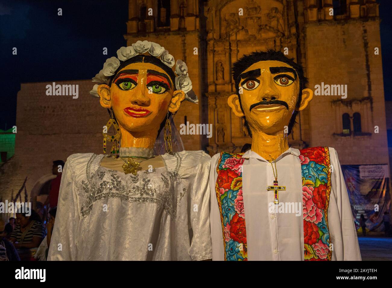 Giant puppets dressed as a bride and groom during a Calenda, a ...