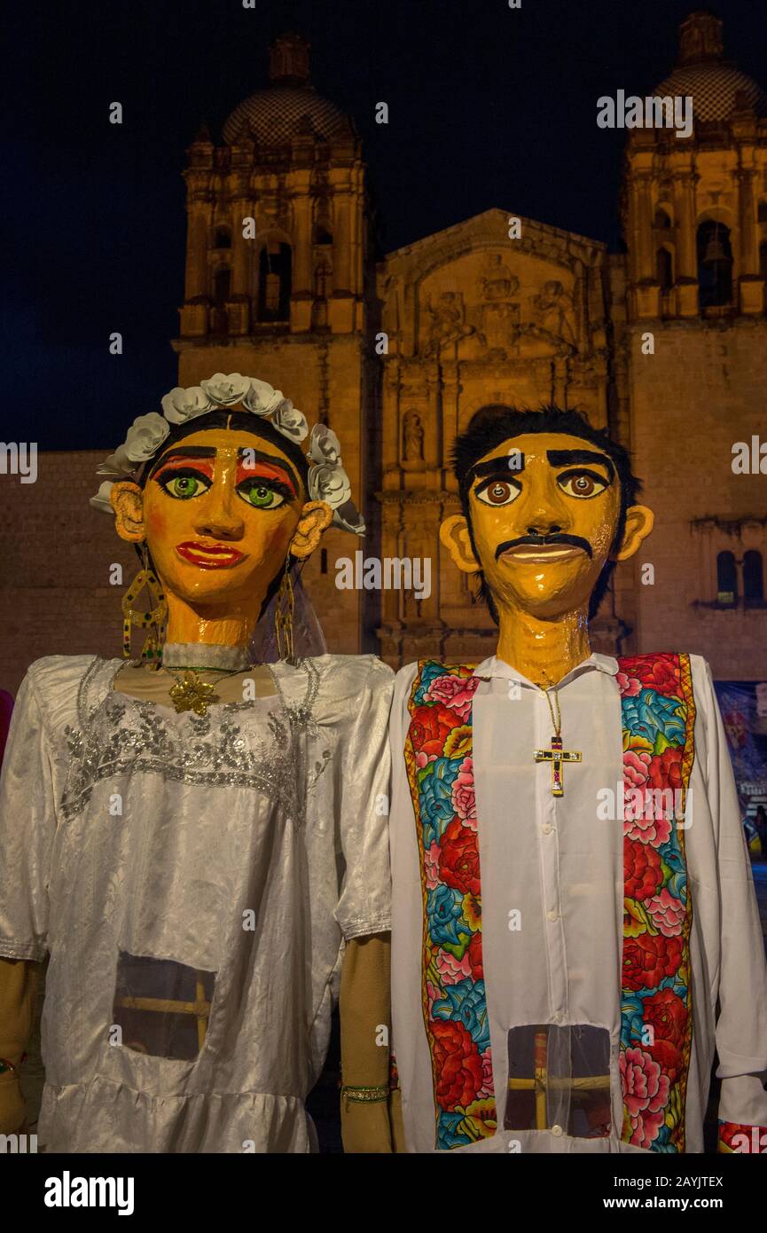 Giant puppets dressed as a bride and groom during a Calenda, a ...