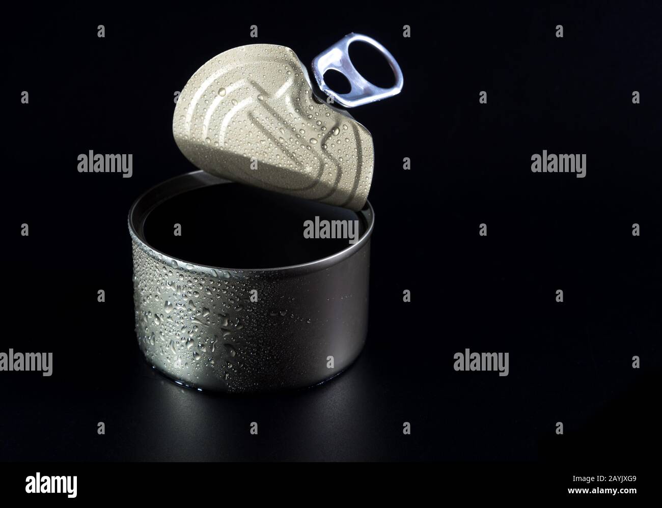 Opened pull cap of empty food can on black background Stock Photo - Alamy