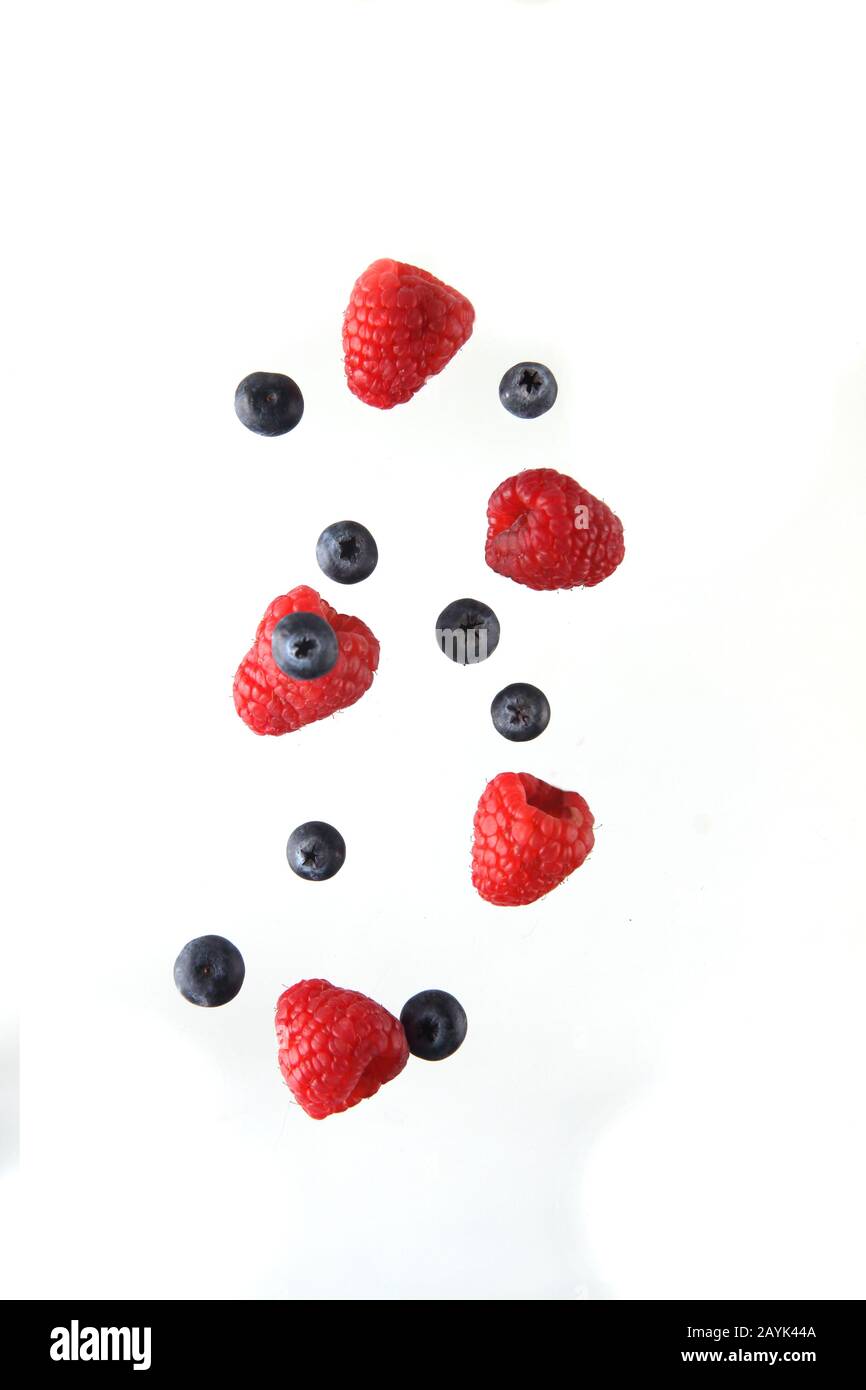 blueberry and raspberry isolated on white background. Concept of flying ...