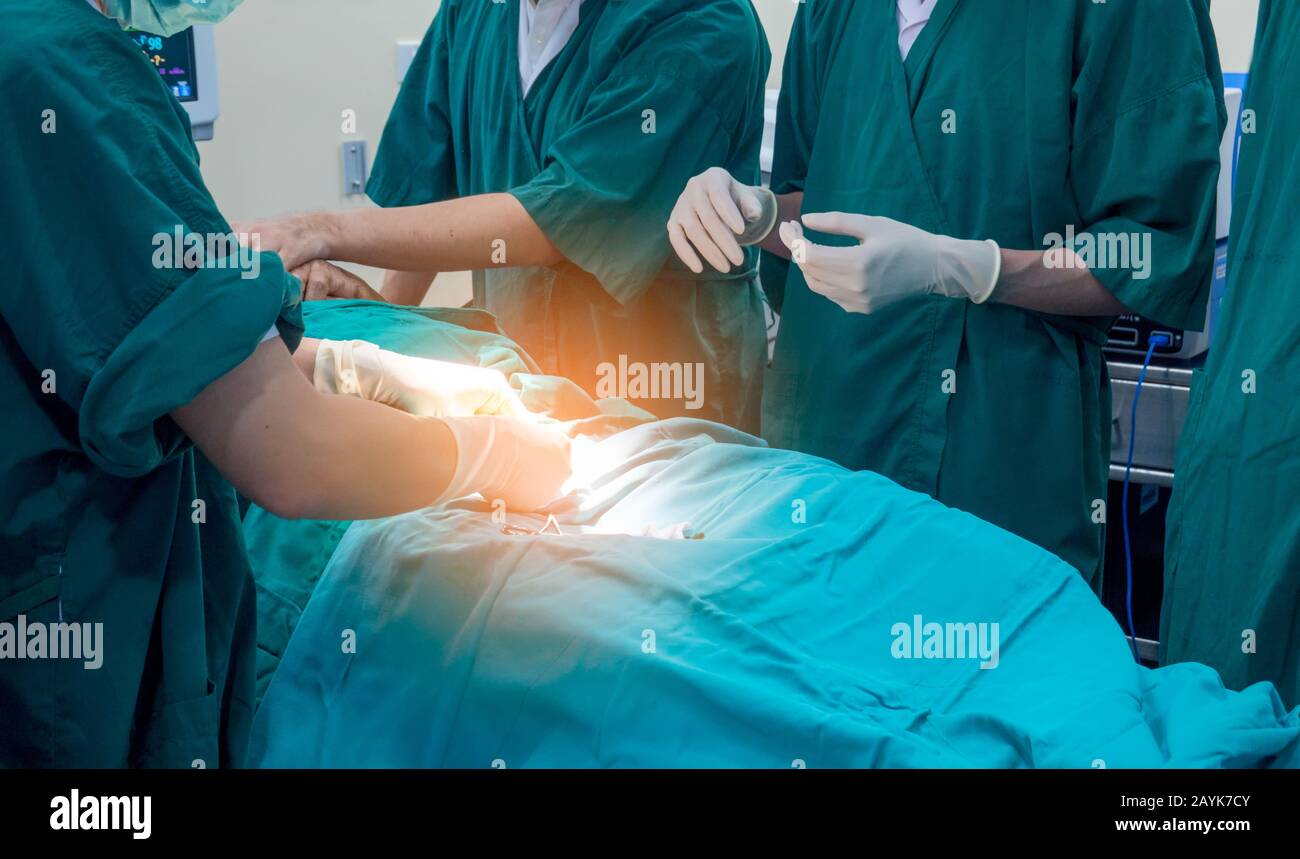 Midsection of surgery team operating Medical Team Performing Surgical ...