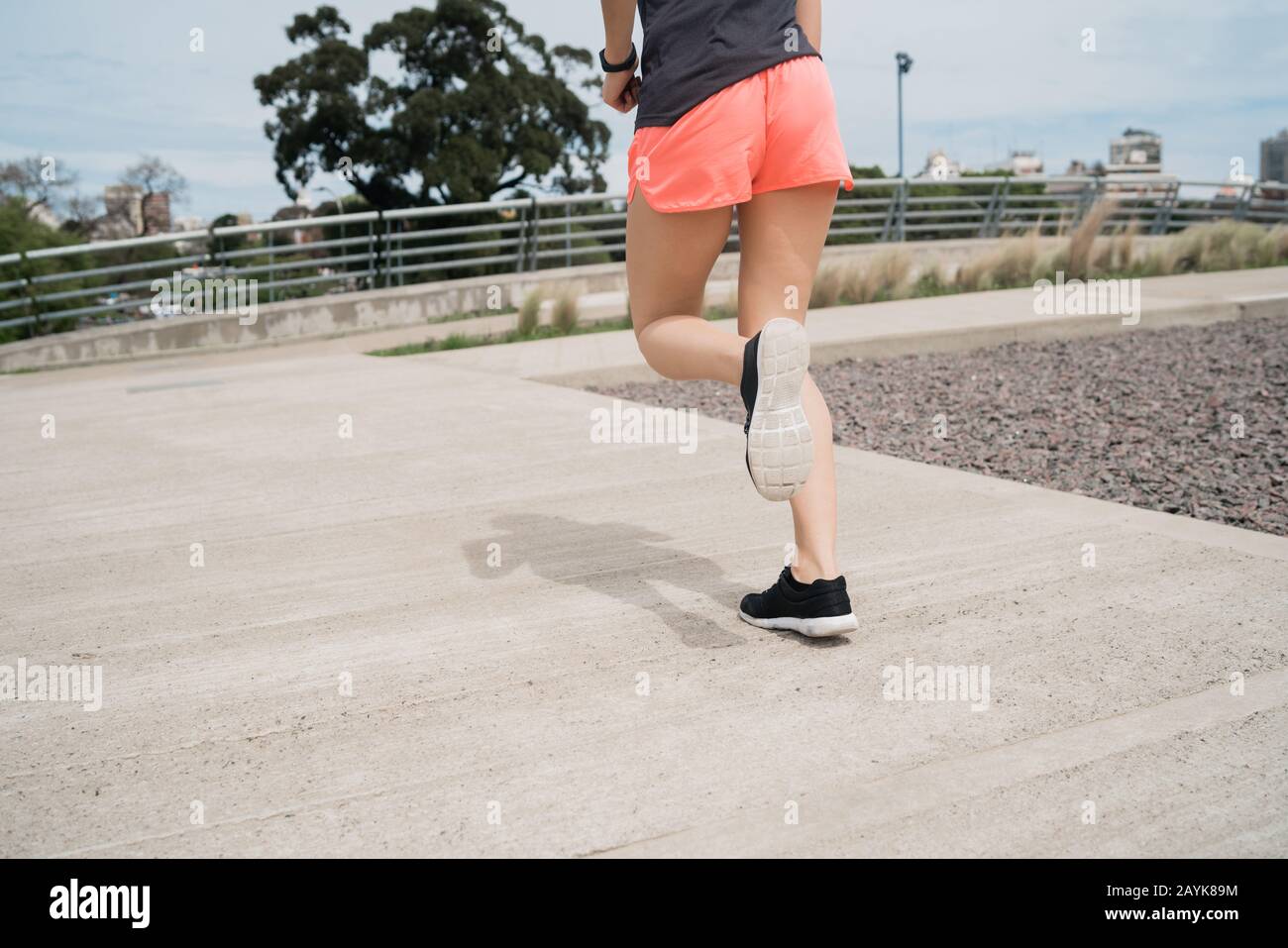Portrait of a fitness woman running outdoors in the street. Sport and ...