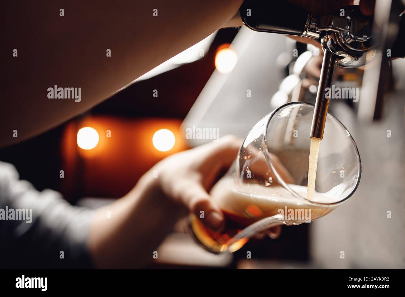 Light Draft cold beer pour in glass from crane in pub Stock Photo - Alamy