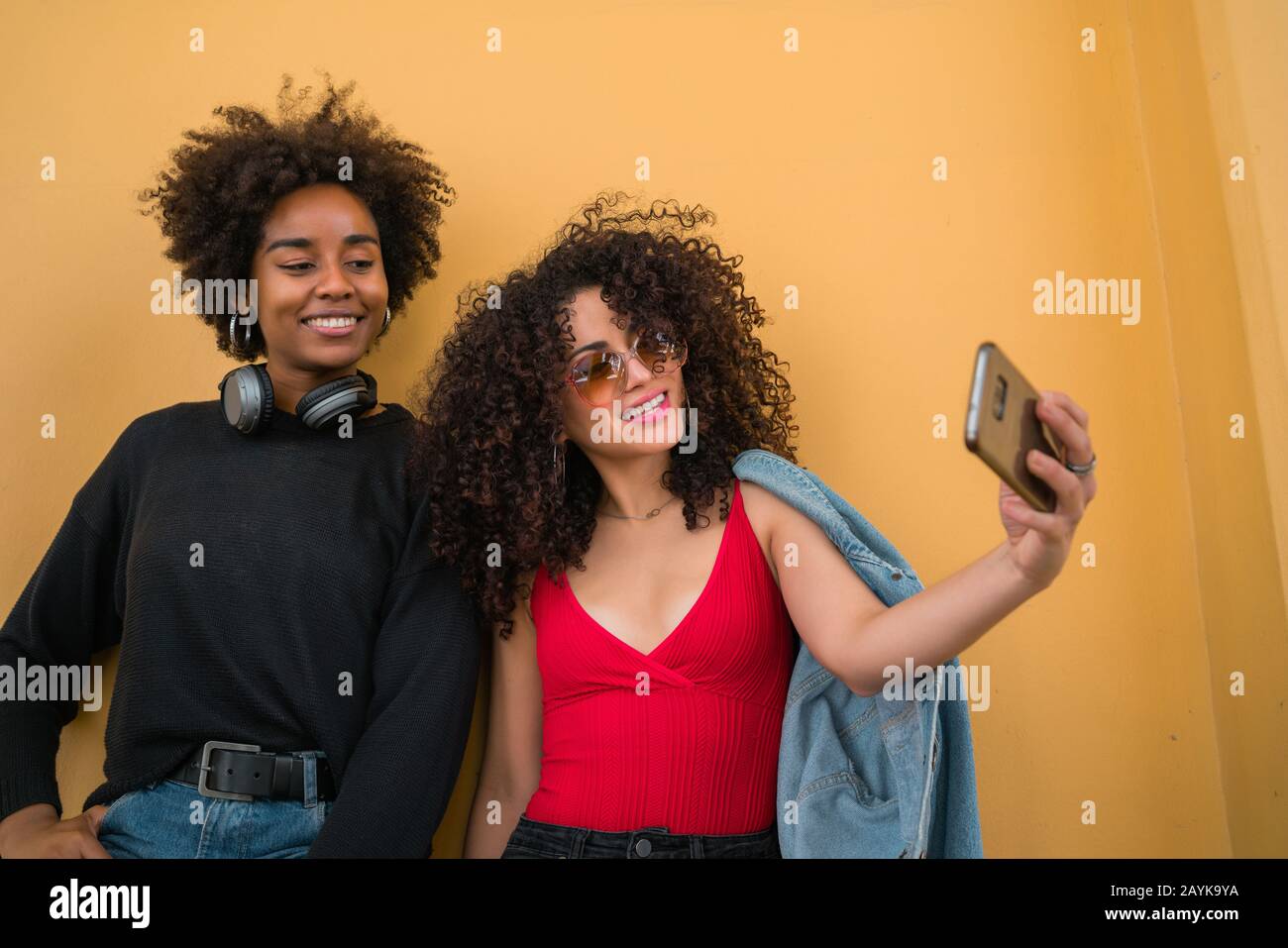 Portrait Of Two Afro Friends Taking Selfies With Her Mophile Phone