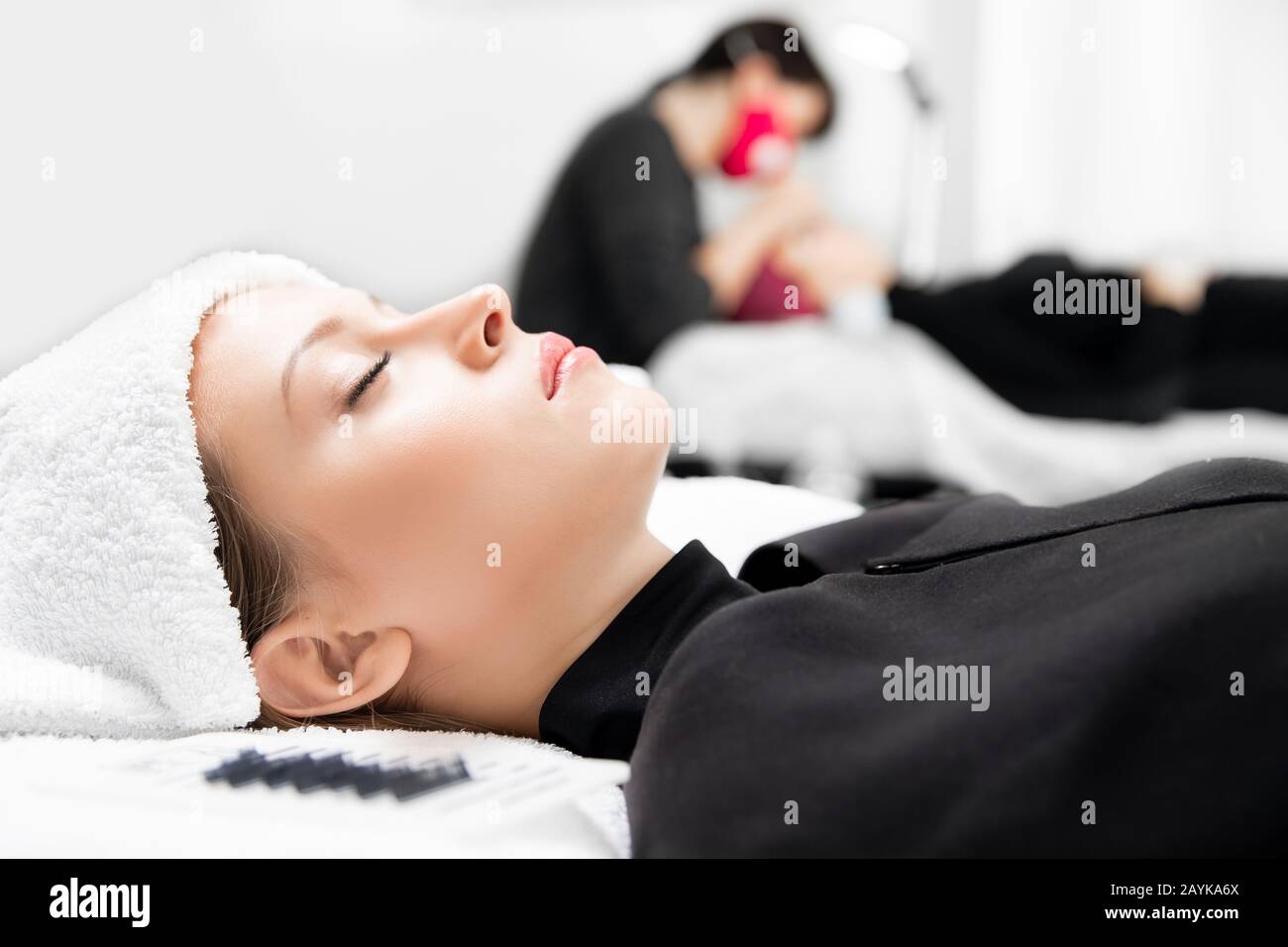 Eyelashes extensions. Lash extension procedure in spa beauty salon ...