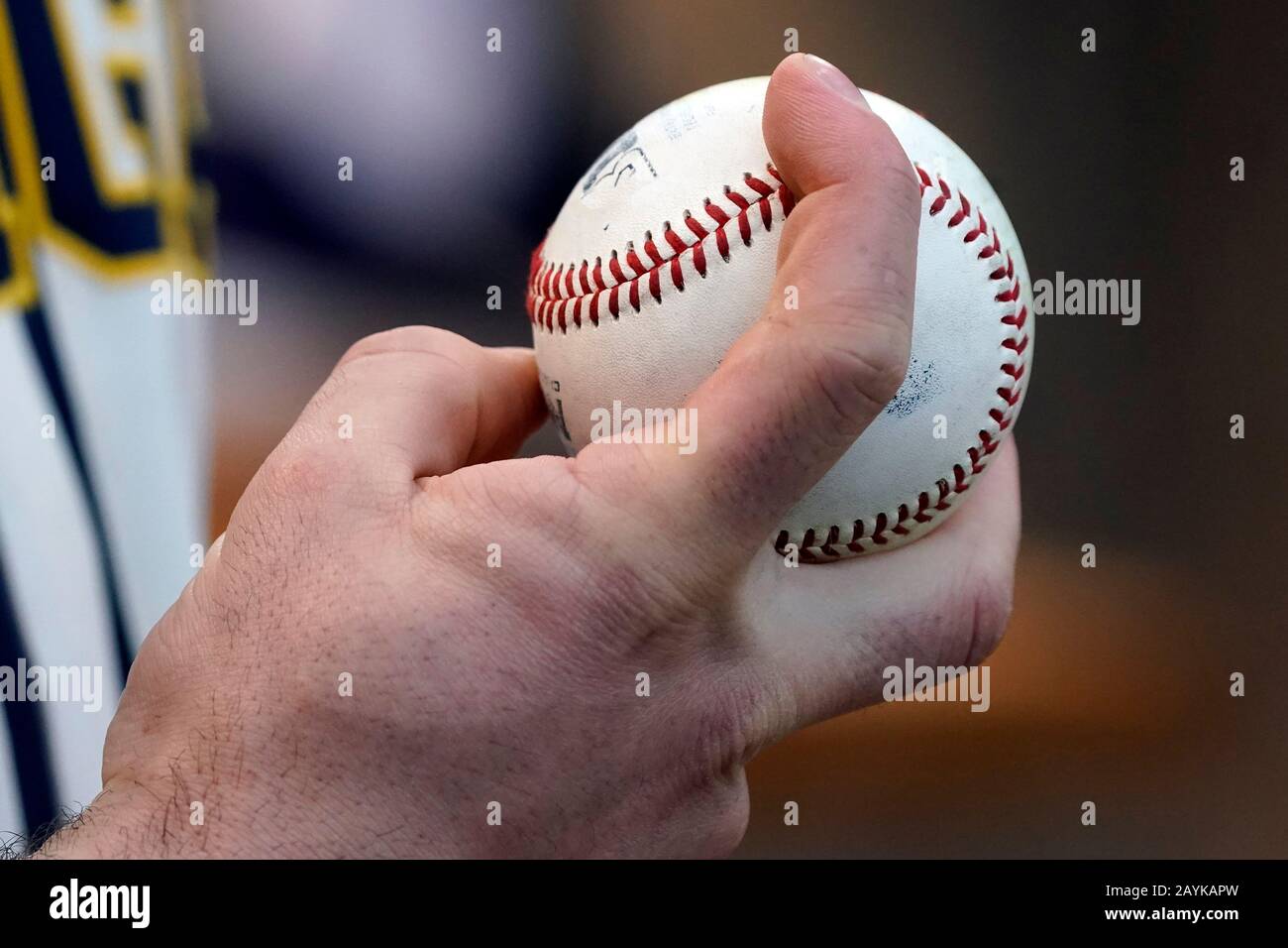A pitcher shows off baseball grips for throwing Stock Photo - Alamy