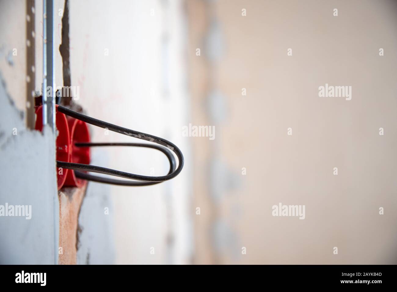 Electrical work with rough finish, electrician connects and mounts ...