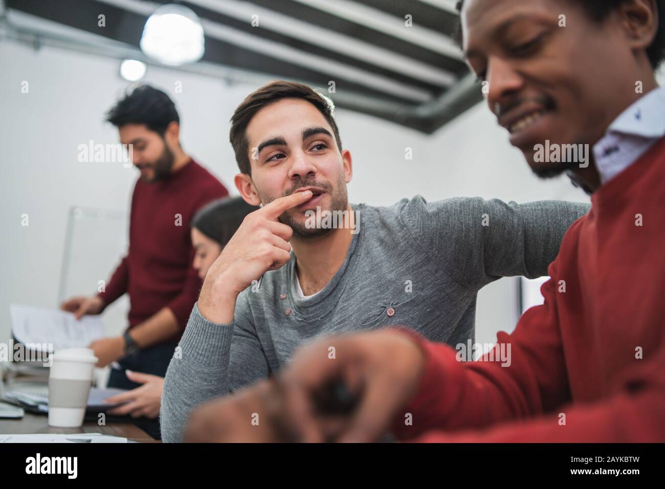 Two creative designers working in a project together and sharing new ...