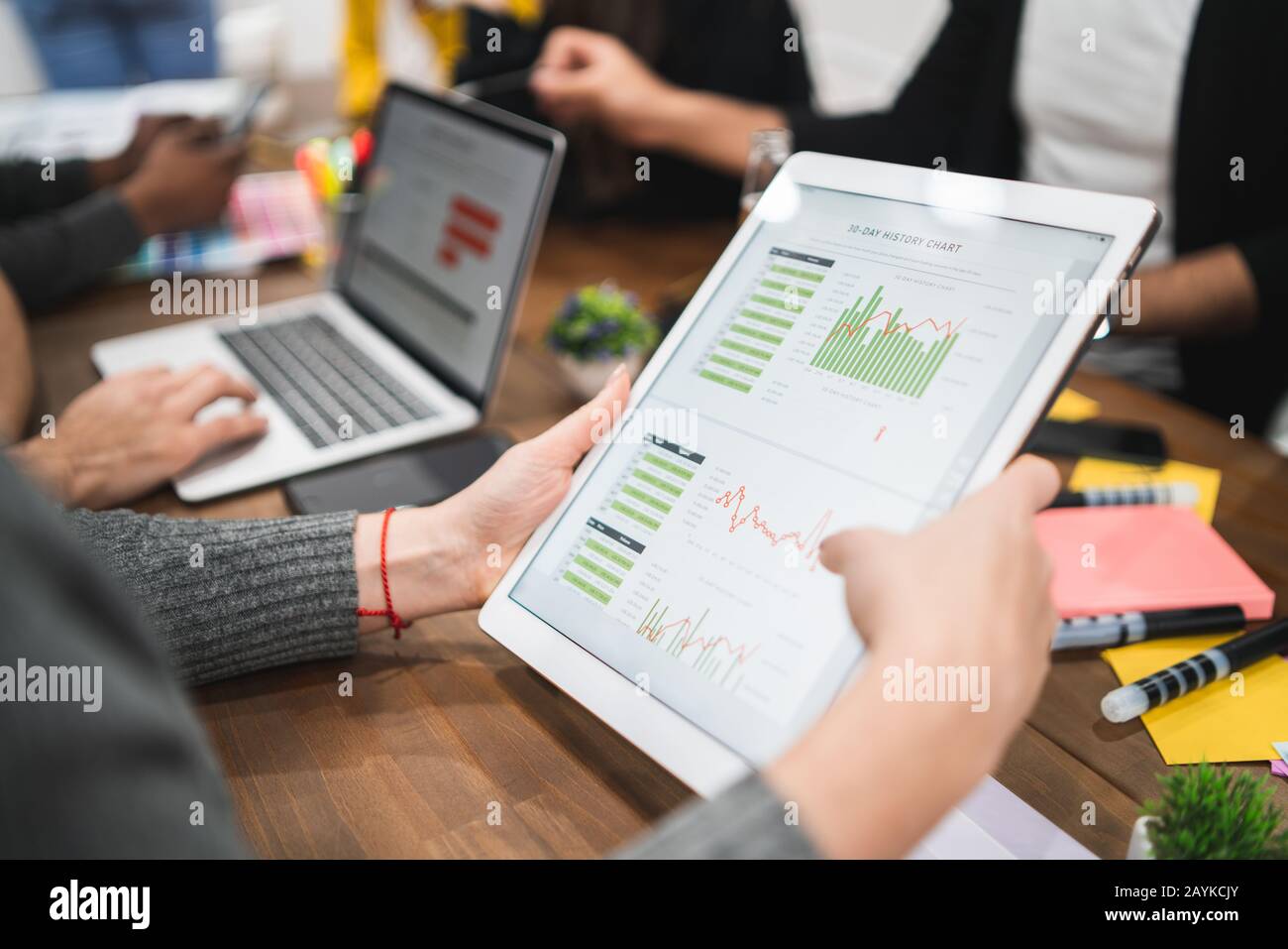 Creative business person working on digital tablet and cheking some ...