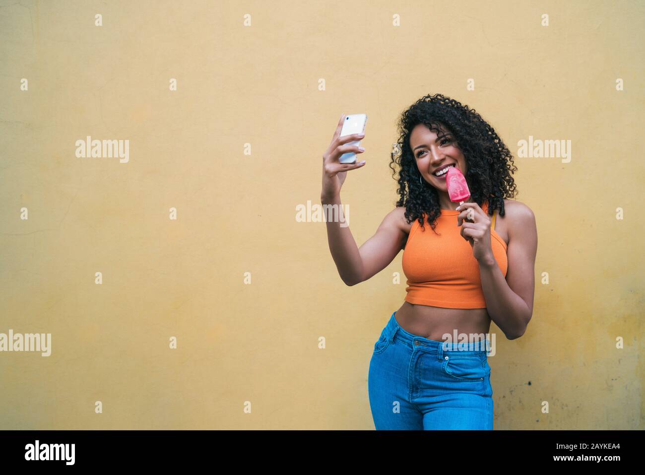 Portrait Of Afro Woman Taking Selfies With Her Mophile Phone While