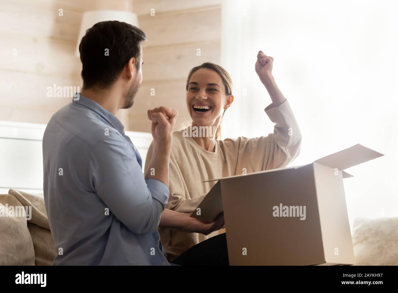 Overjoyed couple smile unpacking online order at home Stock Photo - Alamy