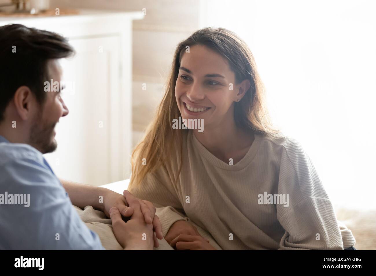 Couple flirting on sofa hi-res stock photography and images - Alamy