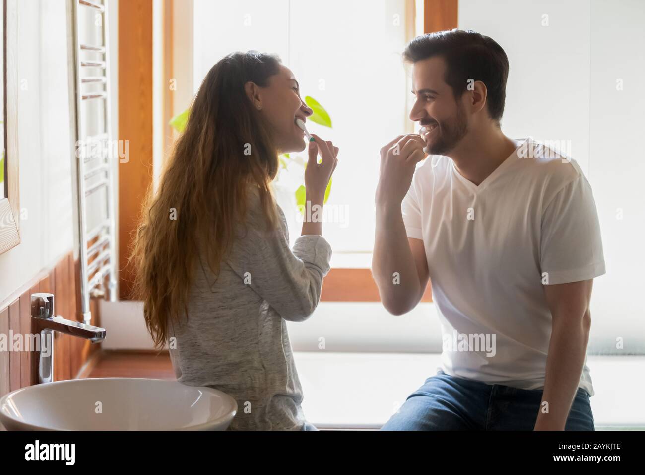 Happy millennial couple enjoy morning routine in bathroom Stock Photo ...