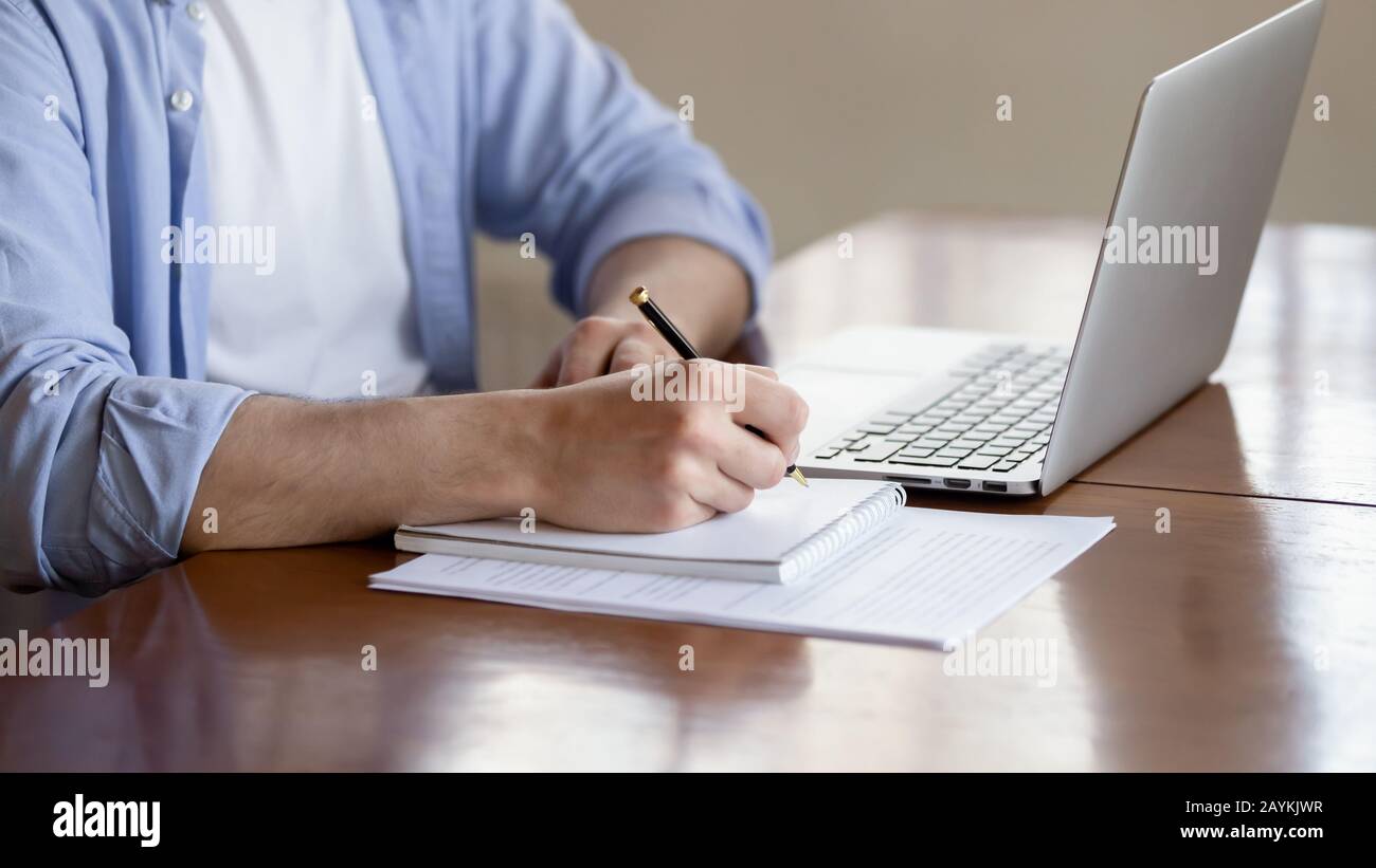 Focused male student make notes studying online Stock Photo - Alamy Focused male student make notes studying online Stock Photo - Alamy